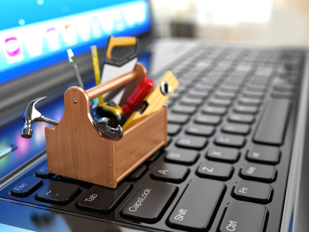Online support. Toolbox with tools on laptop. | Axiom Marketing